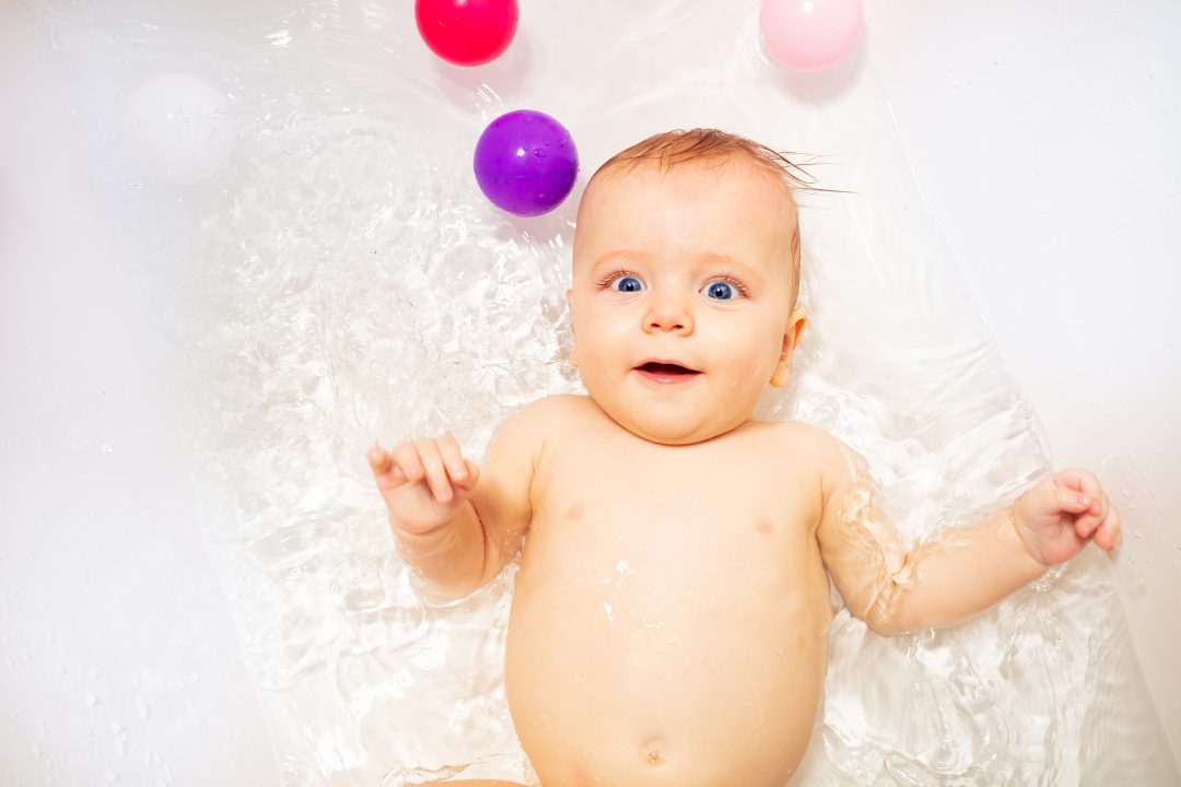 Smiling baby portrait bathing in water at home - One with the Water